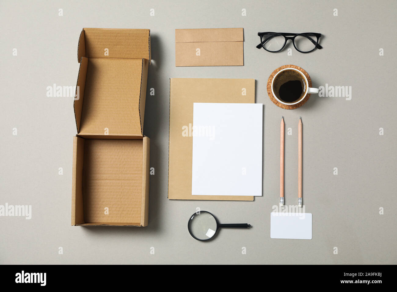 Mockup. Corporate stationery, glasses and magnifier on grey background ...