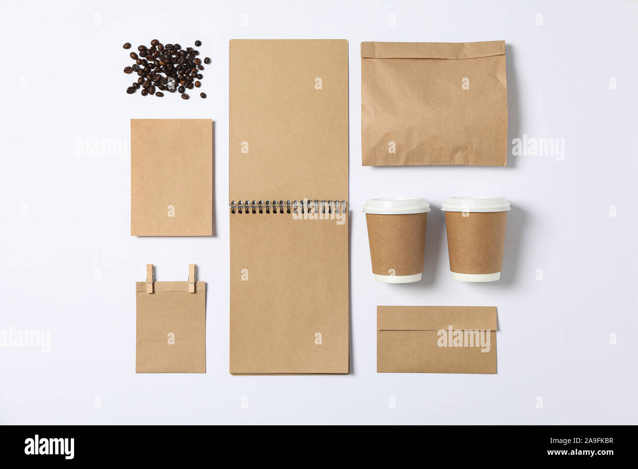 Flat lay. Blank stationery, paper cups and bunch of coffee on white ...