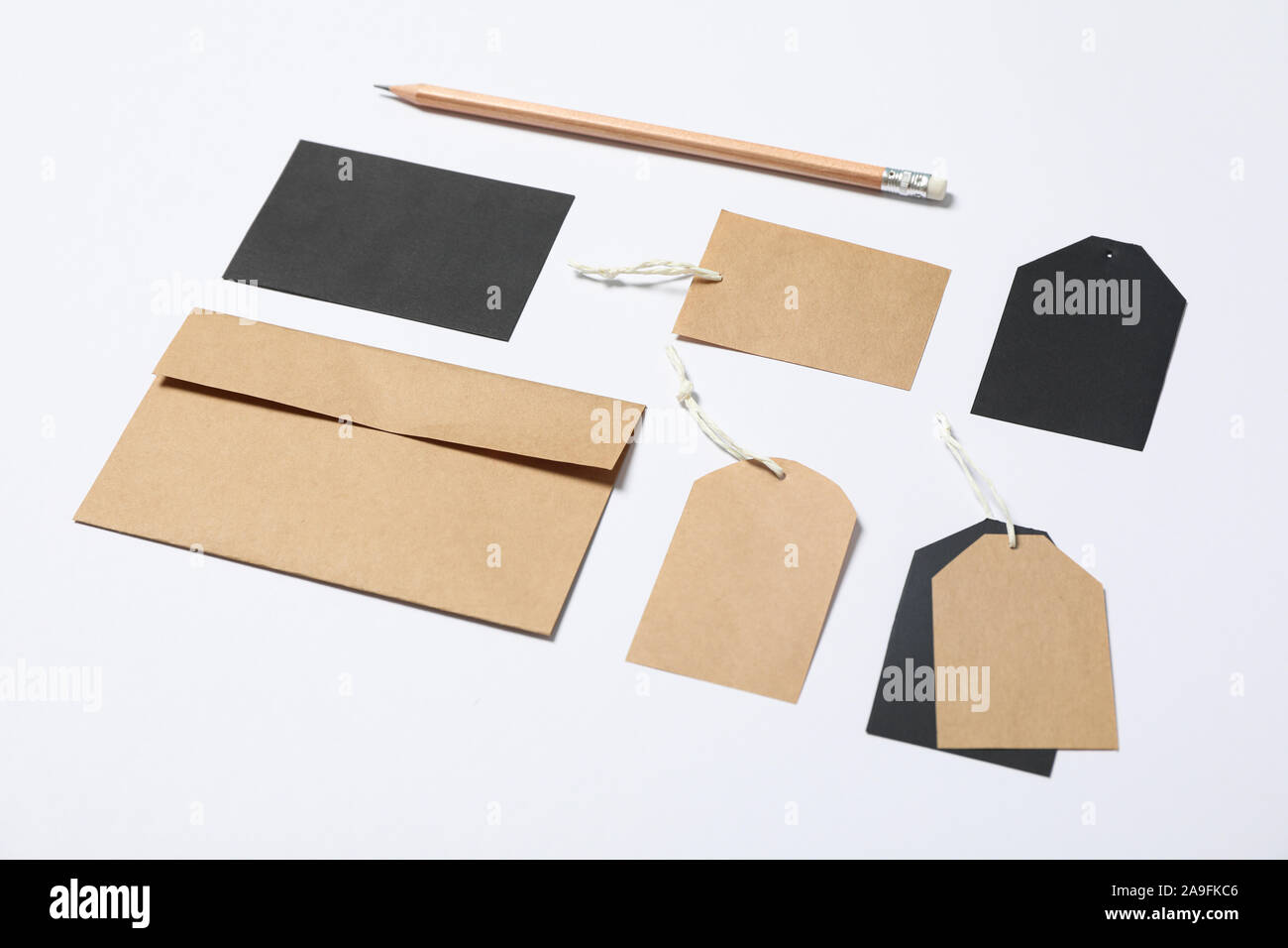 Envelope, tags and pencil on white background, mockup Stock Photo - Alamy
