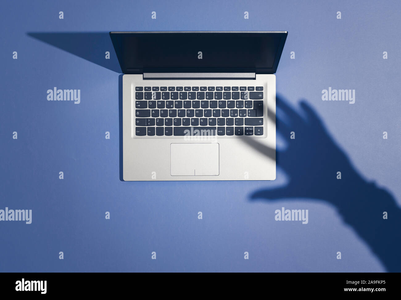 Threatening hand attacking a laptop and stealing information: cyber ...