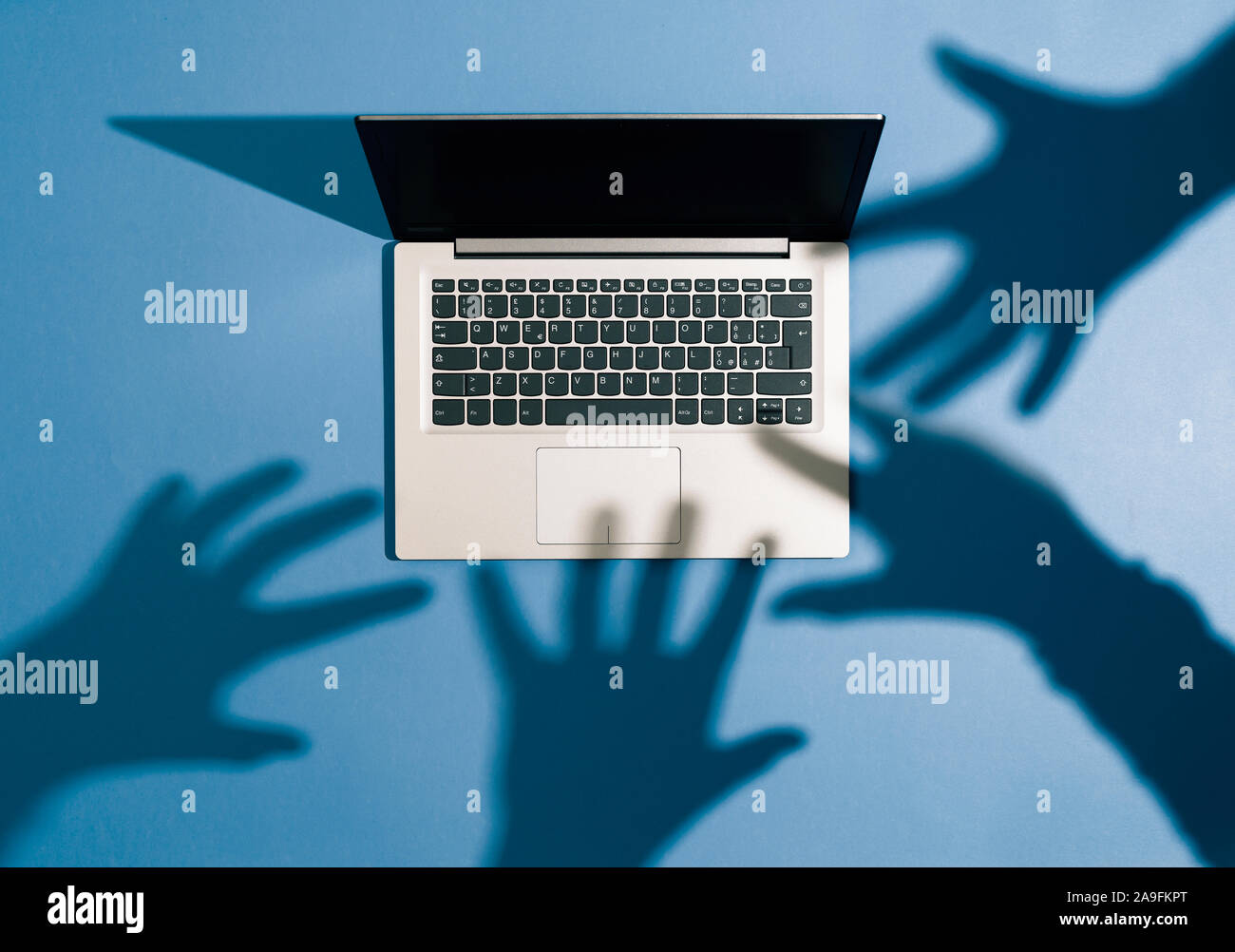 Threatening hands attacking a laptop and stealing information: cyber ...