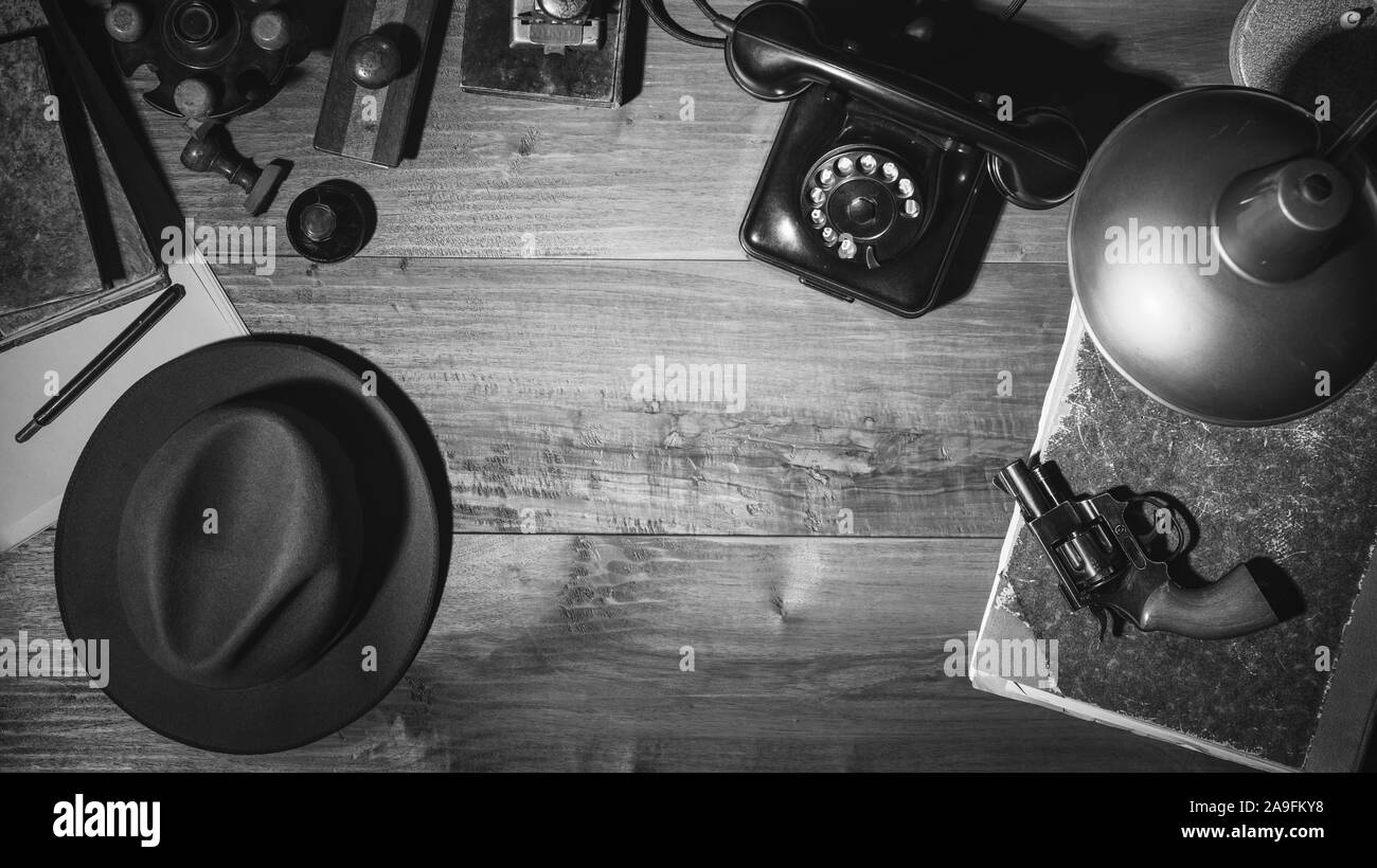 Noir 1950s style detective vintage desktop with revolver, fedora hat ...