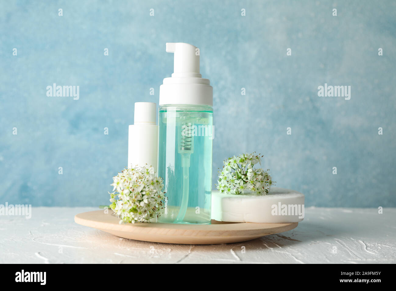 Lotion, allium flowers, sponge and cream on white background, copy ...
