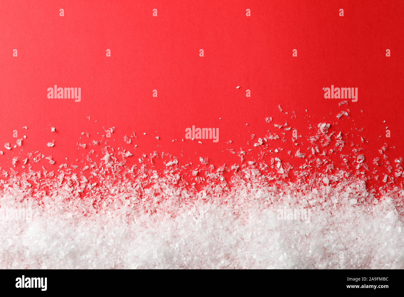 Snow on red background, space for text Stock Photo - Alamy