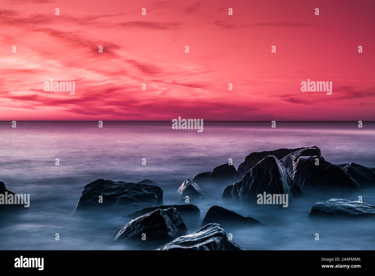 Colorful sunset at the sea at golden hour Stock Photo - Alamy