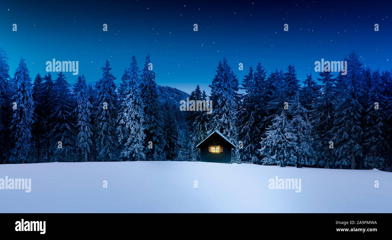 Log cabin with glowing window hi-res stock photography and images - Alamy