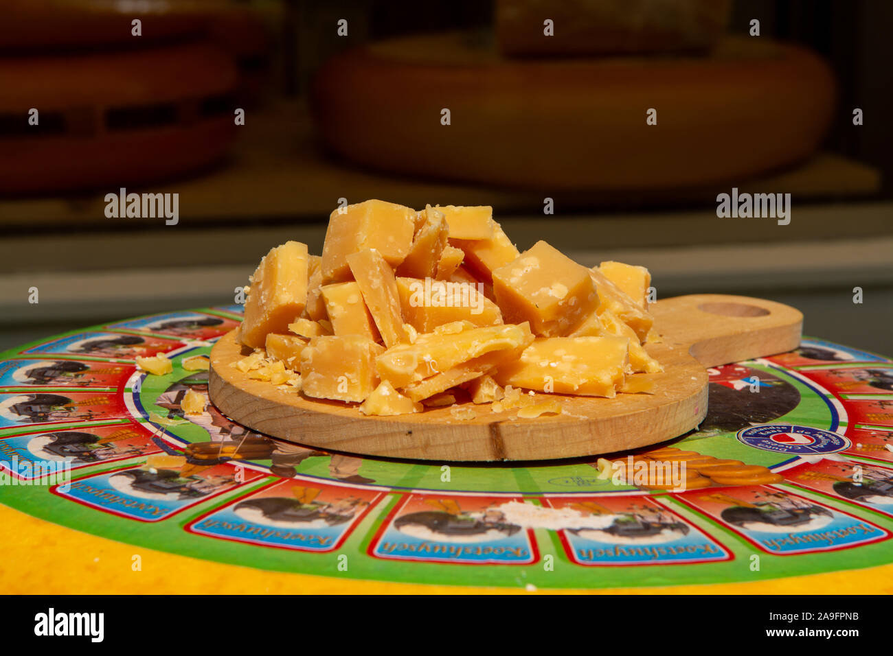 Tasting of old Dutch organic yellow cheese in blocks outside of cheese ...
