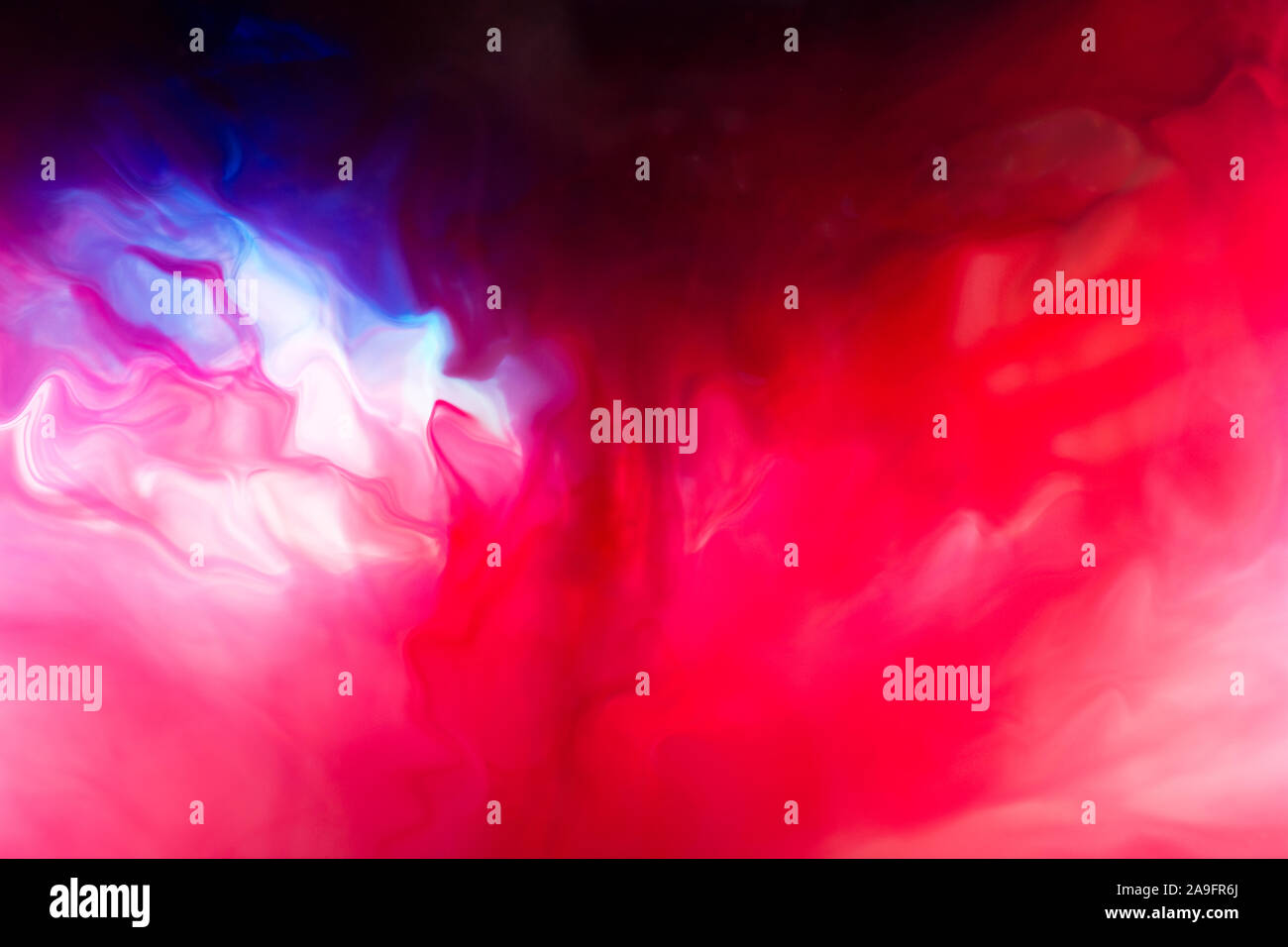 Background with red and blue fluid that diffuses into the liquid Stock ...