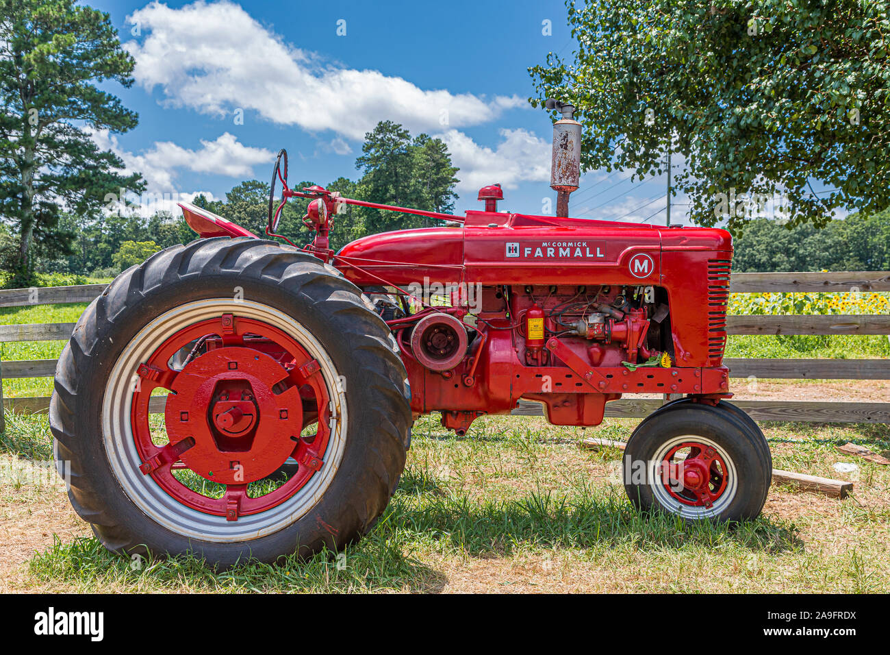 A bright red tractor on a working farm Stock Photo - Alamy