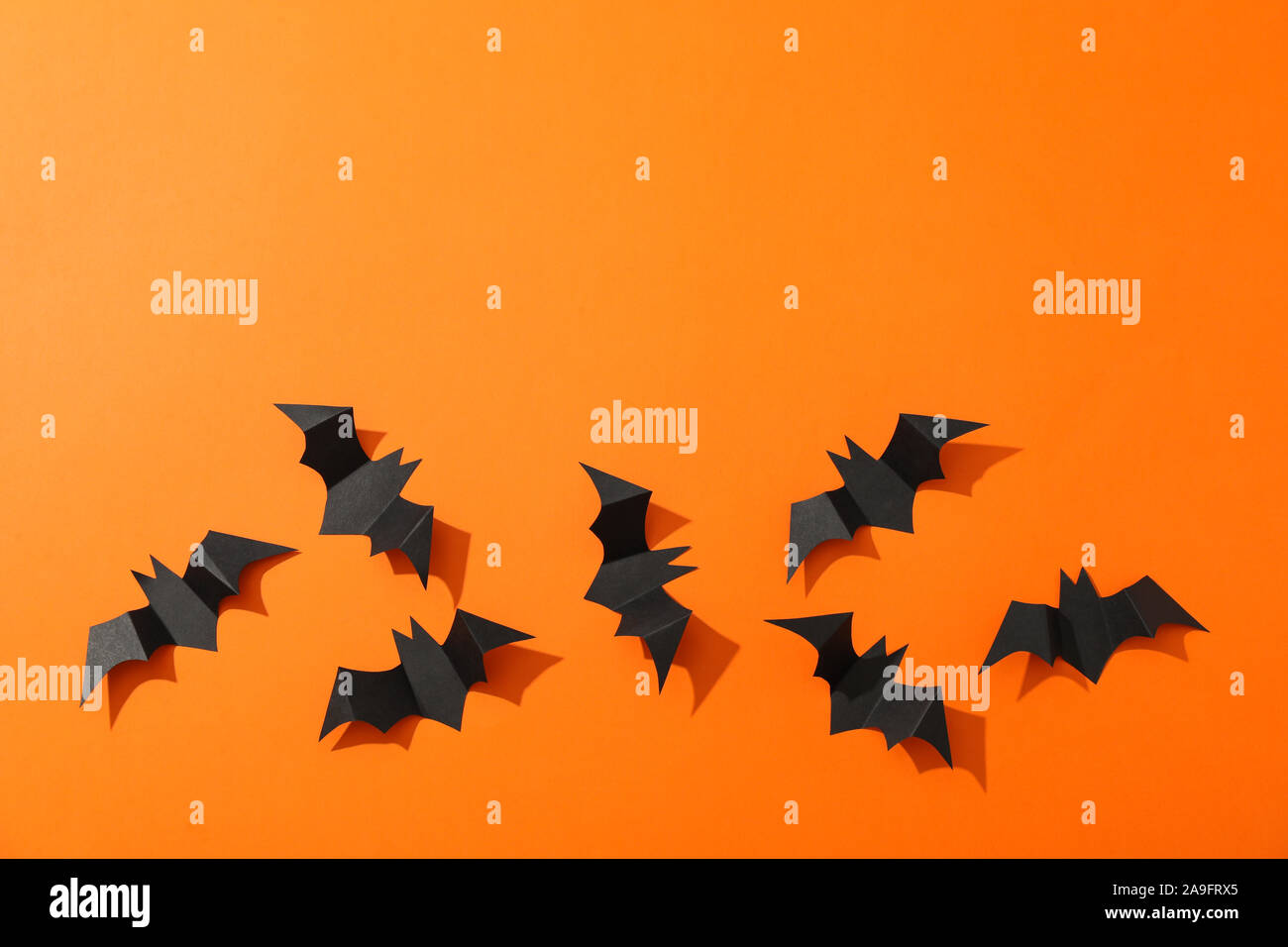 Flat lay with decorative bats on orange background, copy space Stock ...