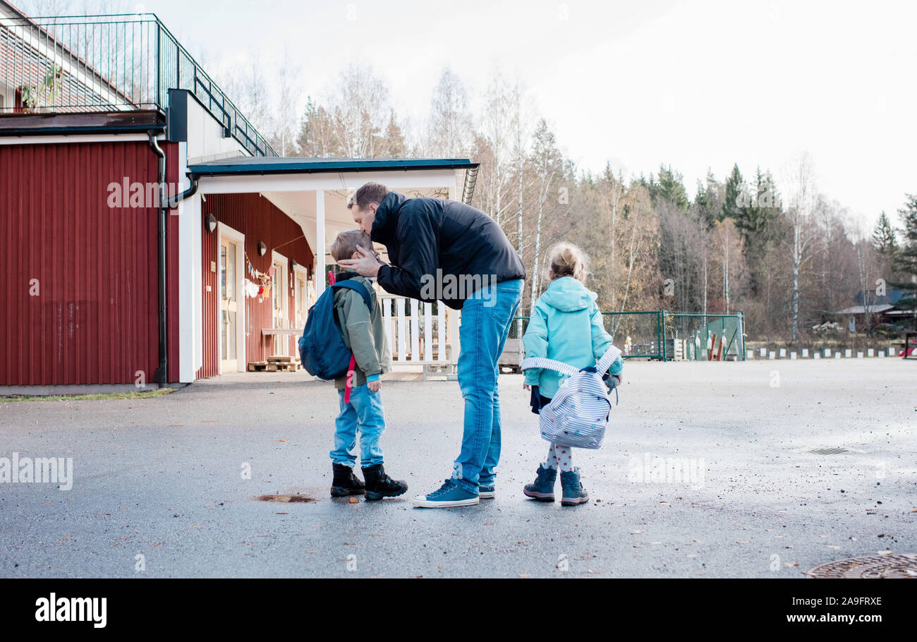 father kissing his kids goodbye at the school gates Stock Photo - Alamy