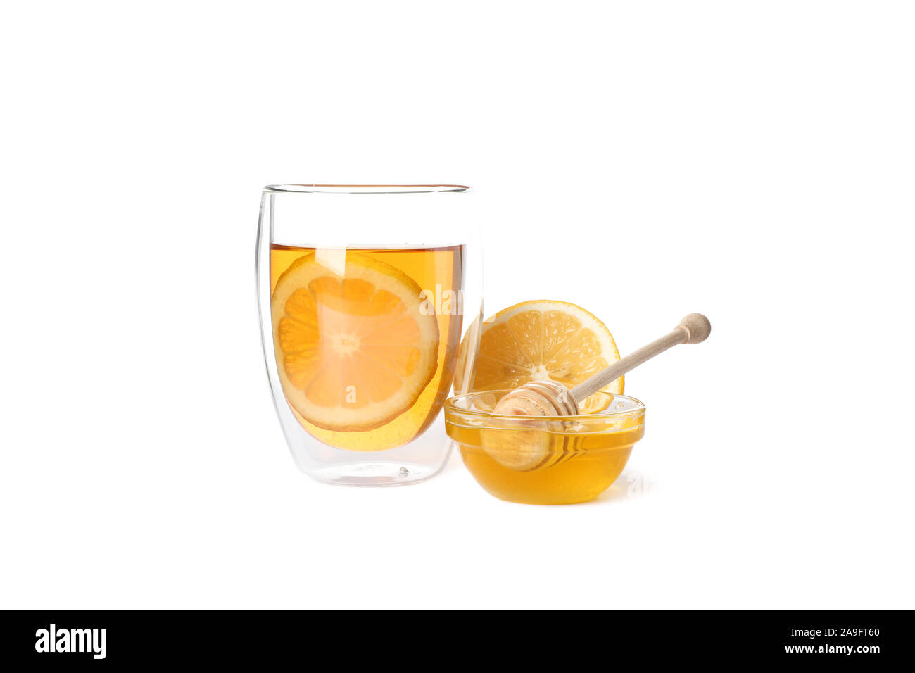 Glass of tea with lemon, honey and dipper isolated on white background ...