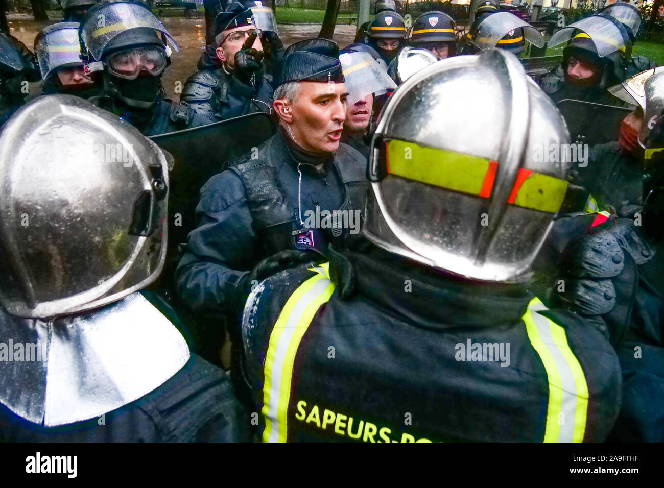 Face to face between striking fire fighters and riot police officers ...