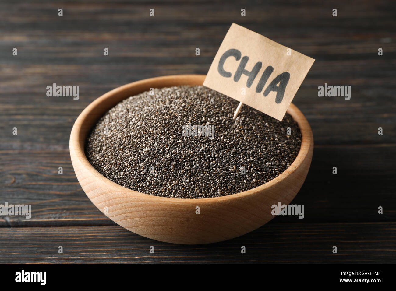 Wooden bowl and word Chia on wood background, copy space Stock Photo ...
