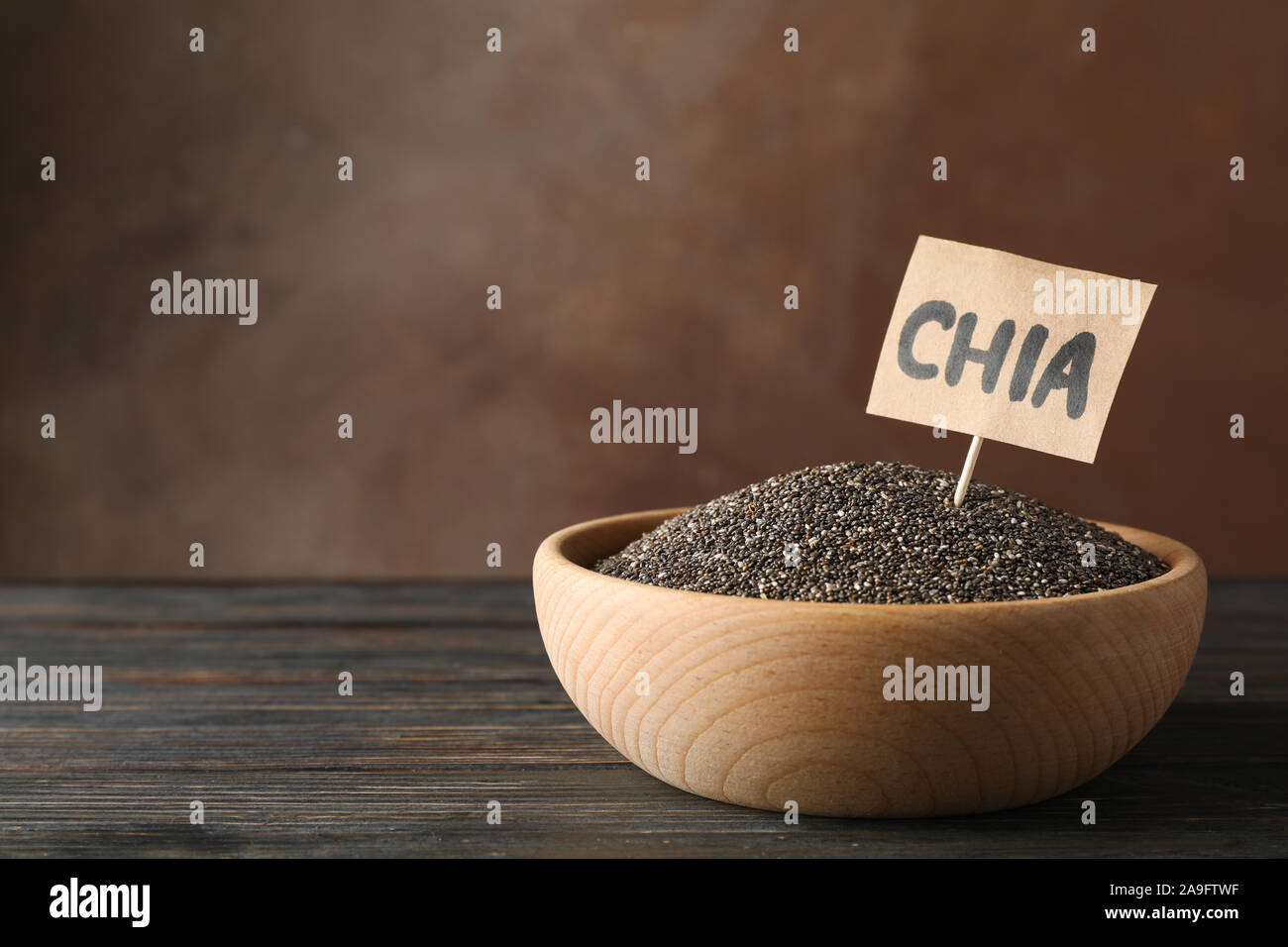 Wooden bowl and word Chia on wood background, copy space Stock Photo ...