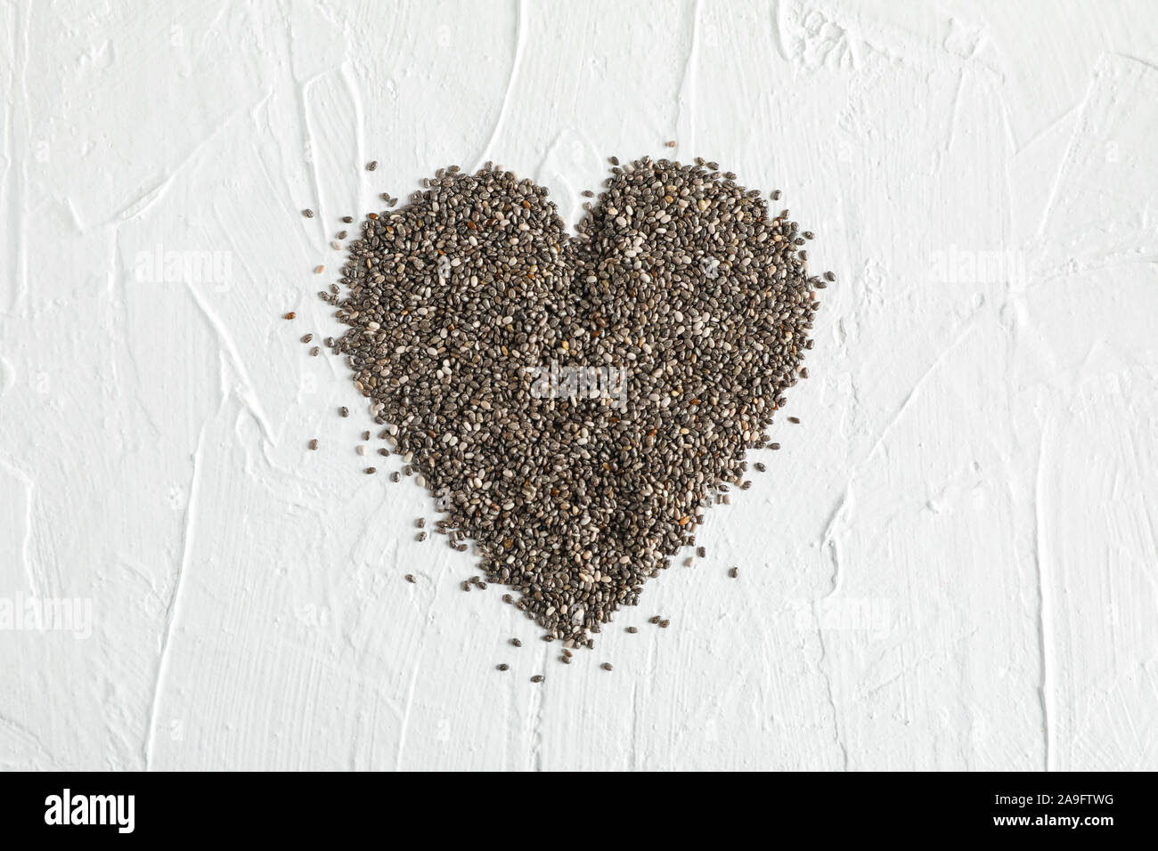 Heart layout of chia on white background, copy space Stock Photo - Alamy