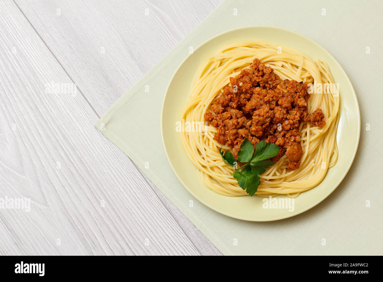 Porcelain plate with spaghetti and bolognese sauce on gray wooden ...