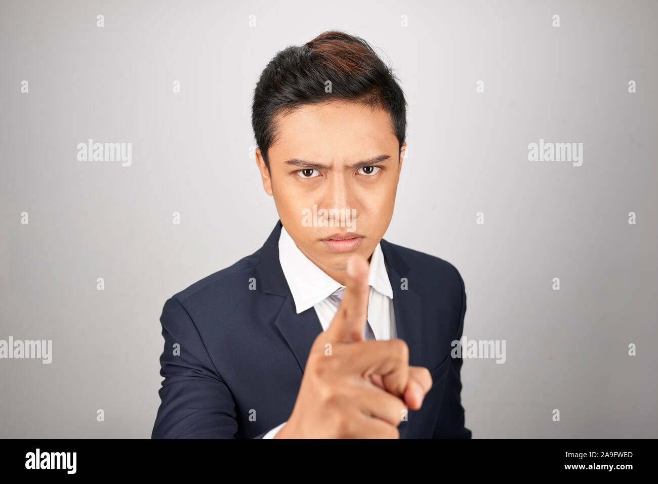 Angry Asian businessman on white background Stock Photo - Alamy