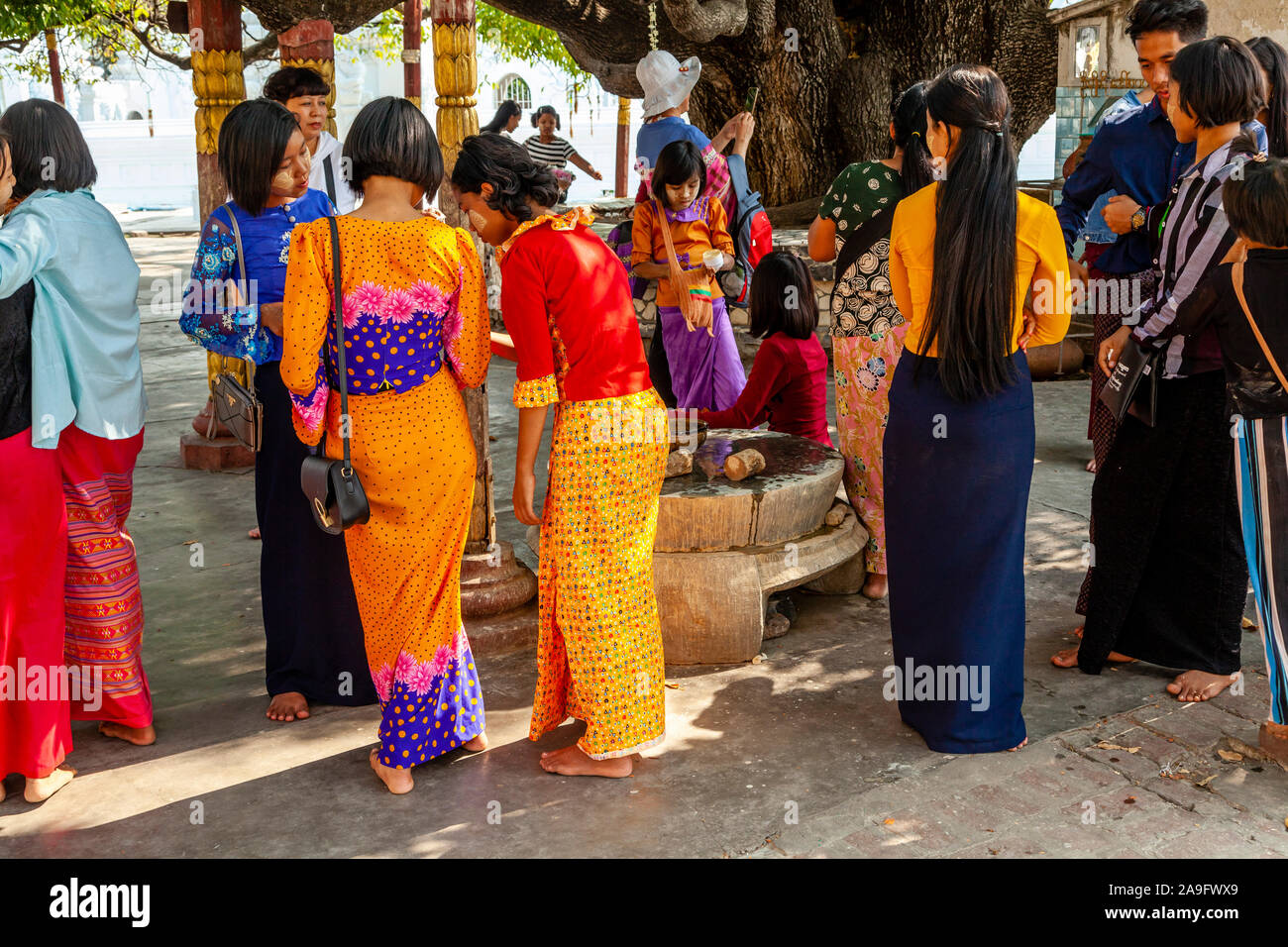 A Group Of Colourfully Dressed Young People At The Kuthodaw Pagoda ...