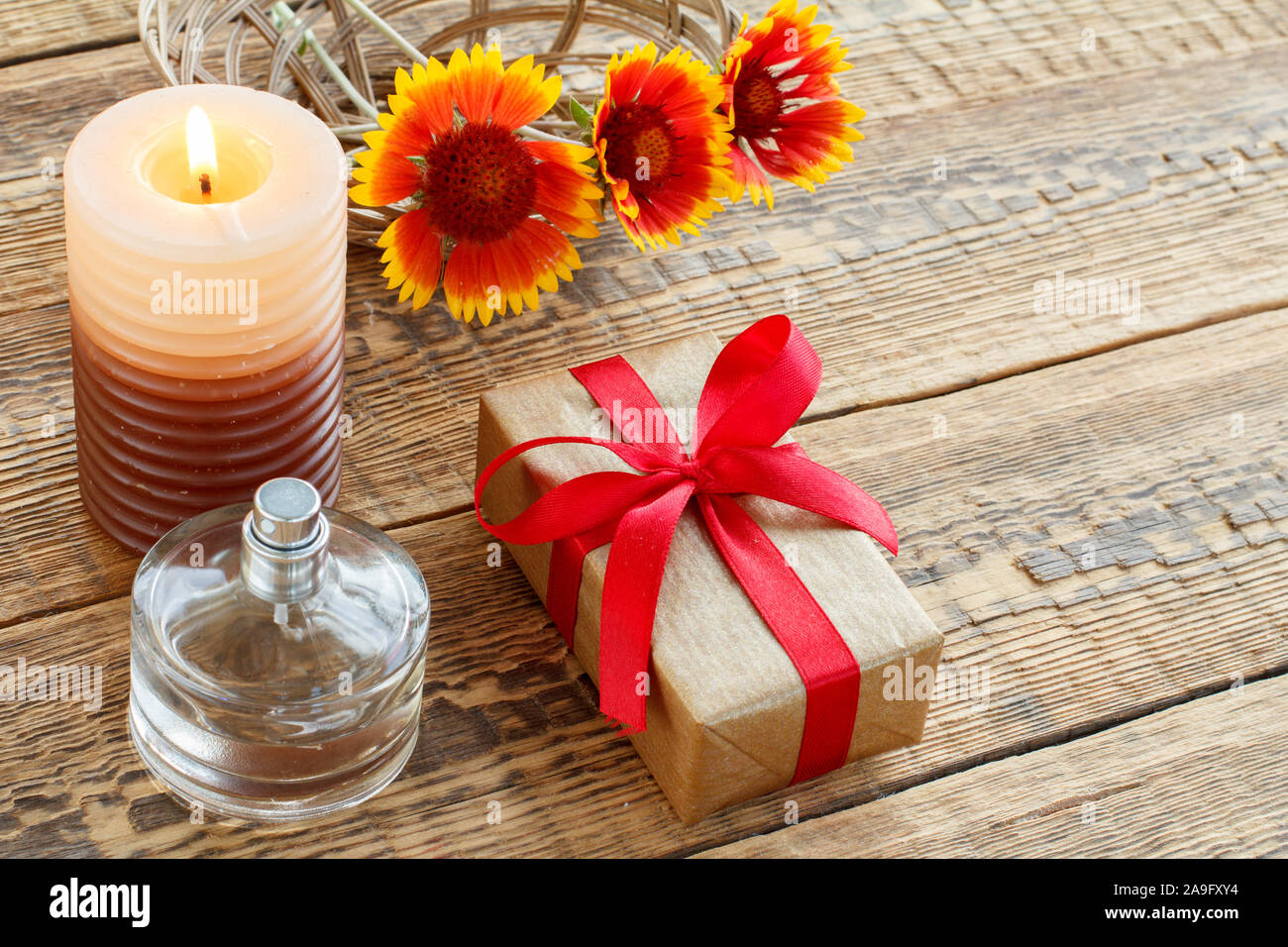 Perfume, gift or present box wrapped in kraft paper with red ribbon ...