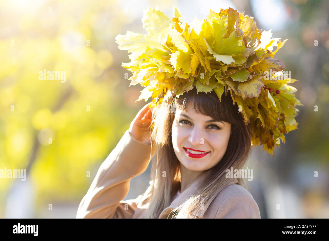 The woman made hat from autumn fallen leaves for the head Stock Photo ...