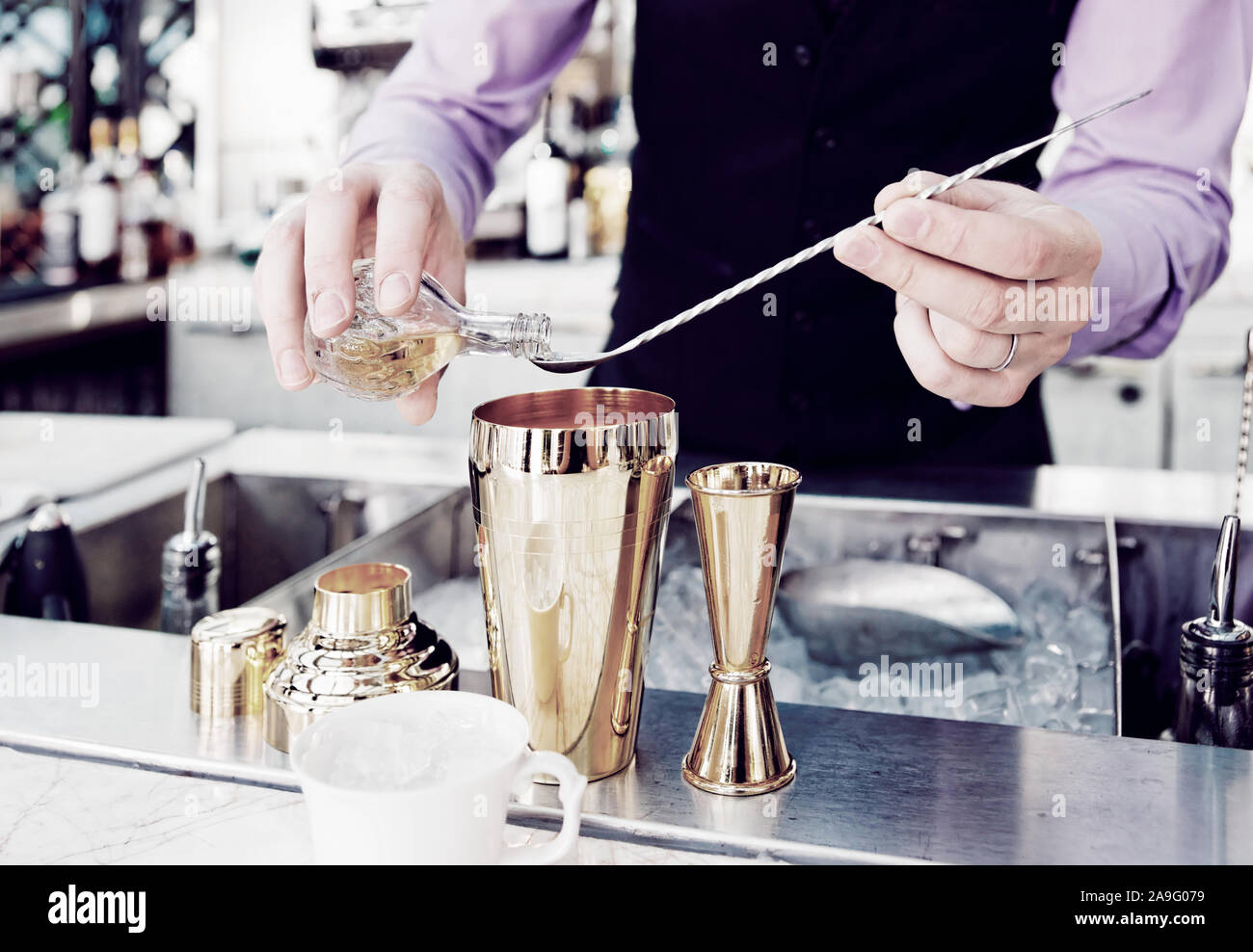 Bartender is adding ingredient in shaker, toned Stock Photo - Alamy