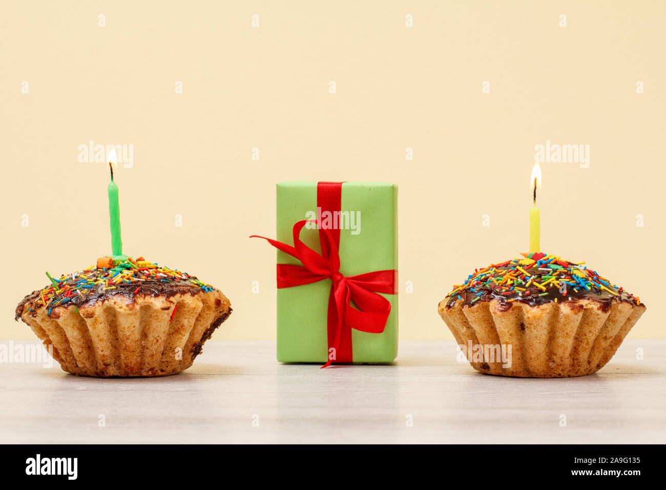 Tasty birthday muffins with chocolate glaze and caramel, decorated with ...