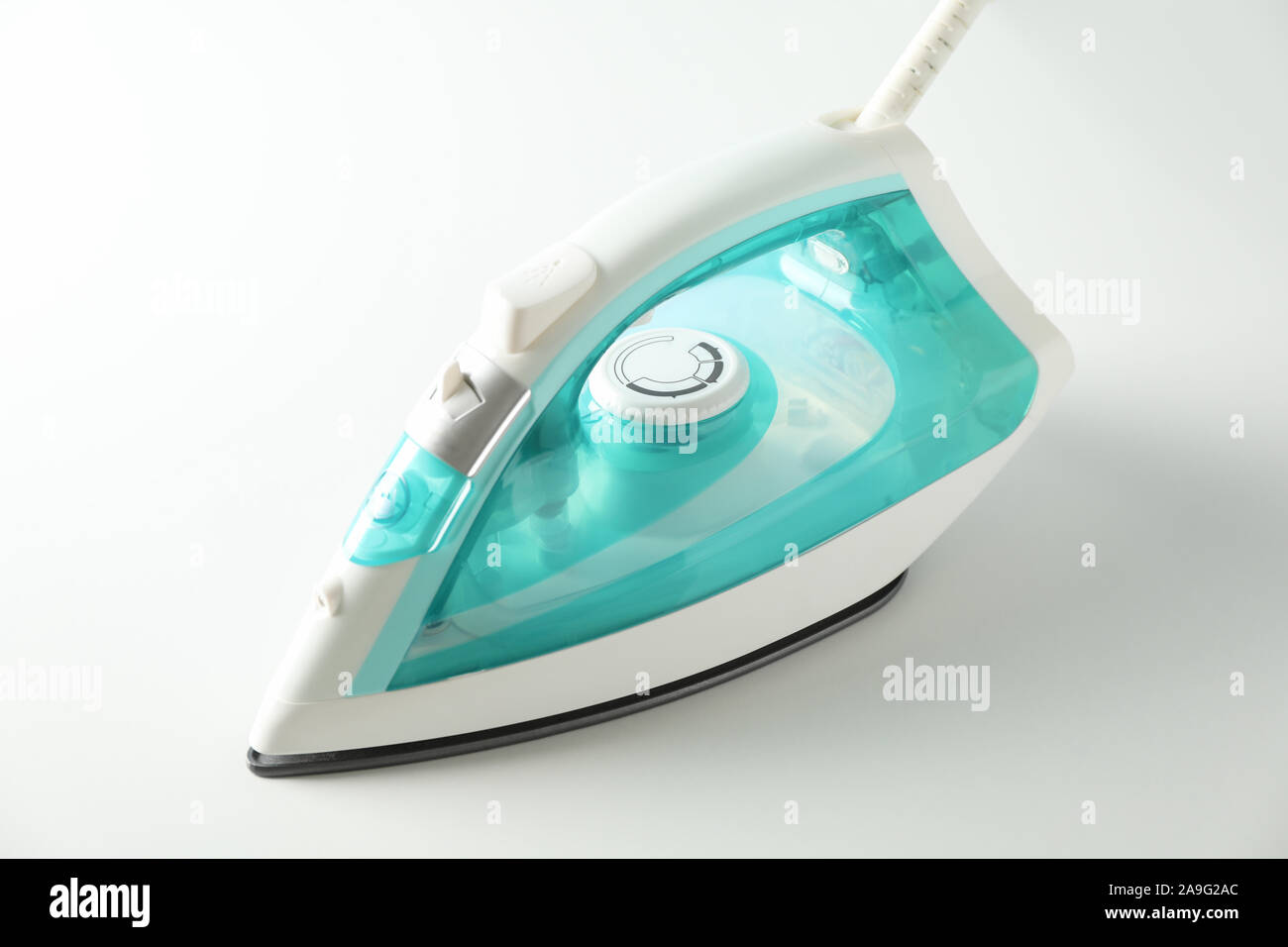 Iron on white background, close up and space for text Stock Photo - Alamy