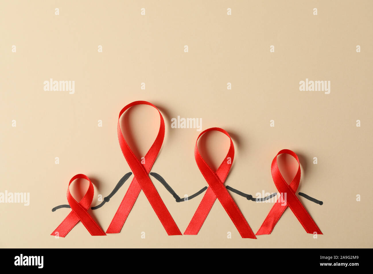Awareness red ribbons on beige background, copy space Stock Photo - Alamy