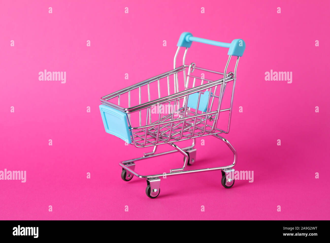 Shopping cart on pink hi-res stock photography and images - Alamy