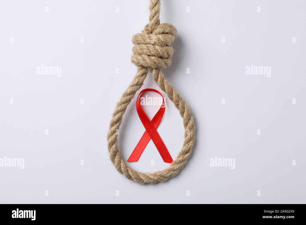 Awareness red ribbon and suicide rope on white background, copy space ...