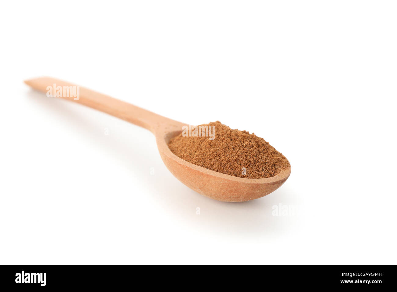 Wooden spoon with cinnamon powder isolated on white background Stock ...