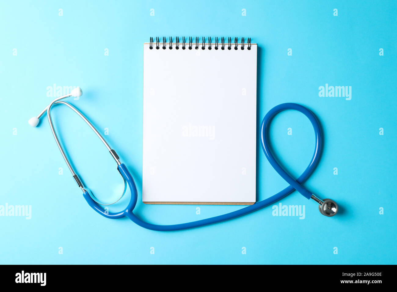 Stethoscope and notepad on a blue background, space for text Stock ...
