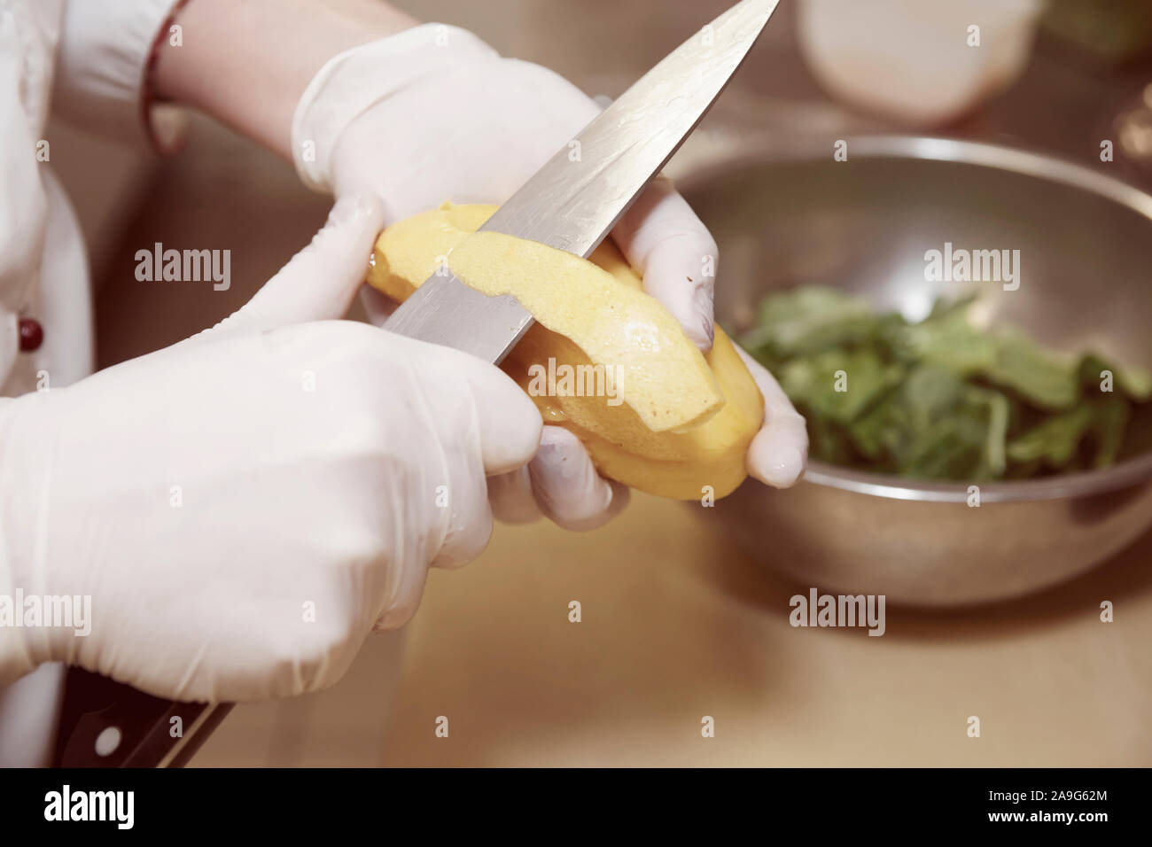 Chef is peeling mango, toned Stock Photo - Alamy