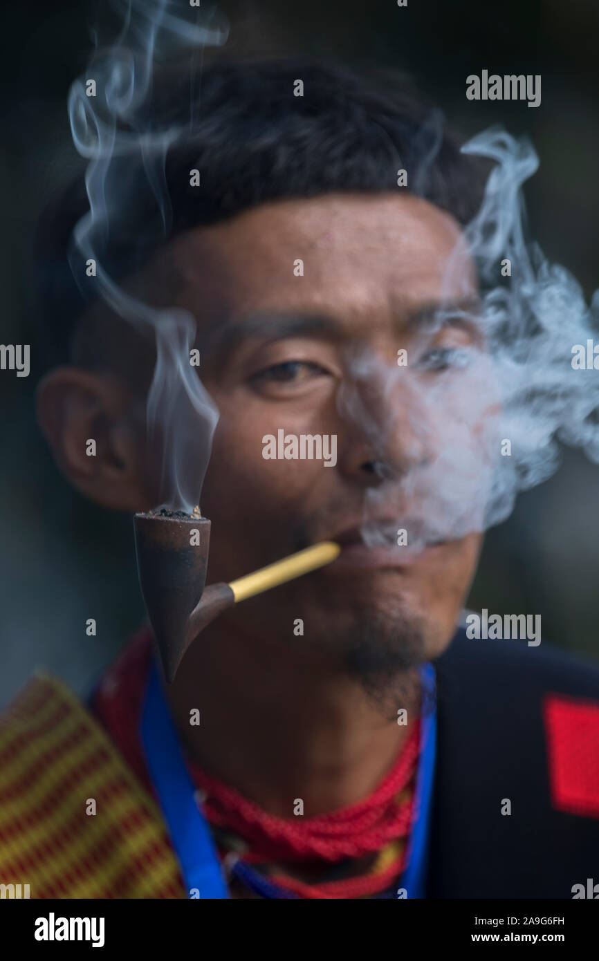 Naga Tribal Man smoking a pipe during Hornbill Festival,Kohima,Nagaland ...