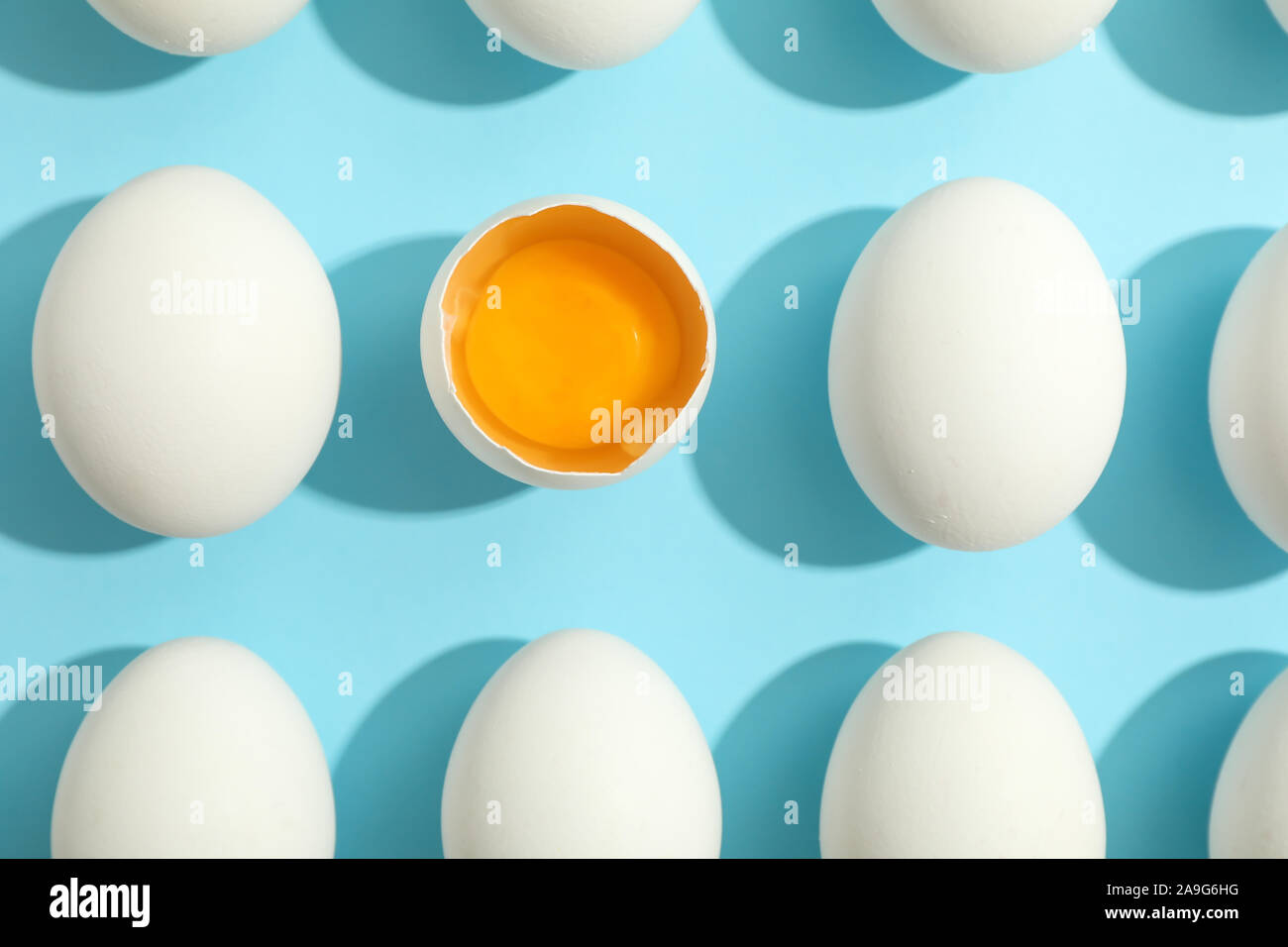 Flat lay composition with chicken eggs and half with yolk on color ...