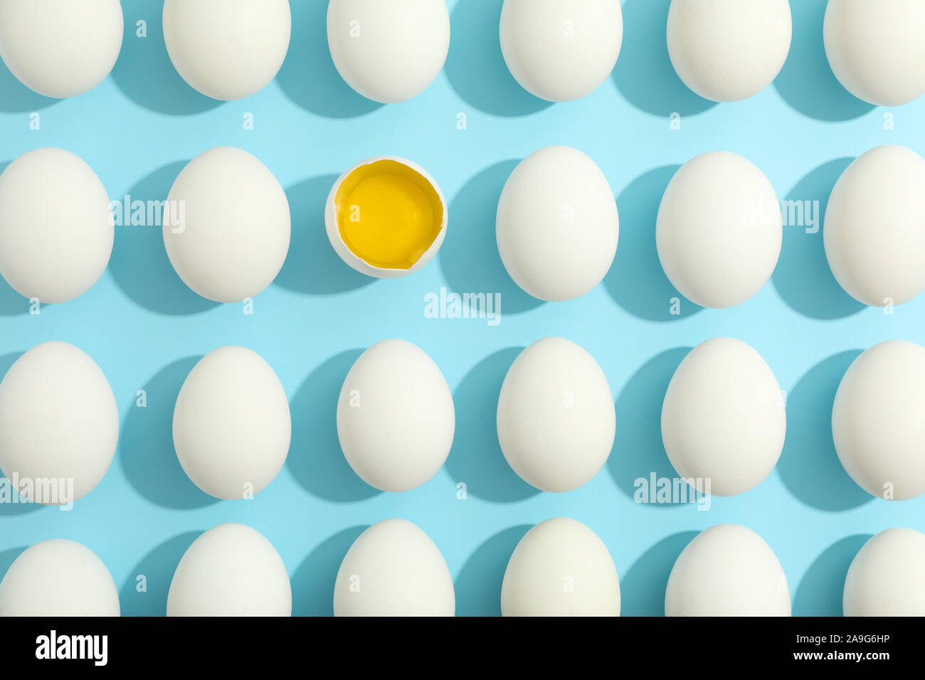 Flat lay composition with chicken eggs and half with yolk on color ...