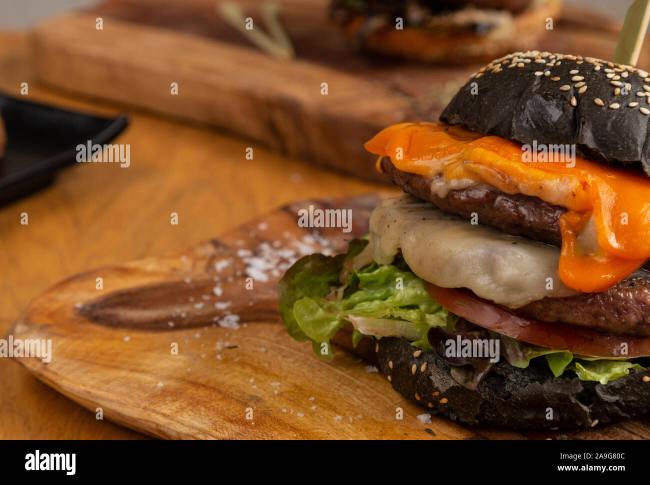 Delicious homemade hamburger of black bread with double burger of 200 ...