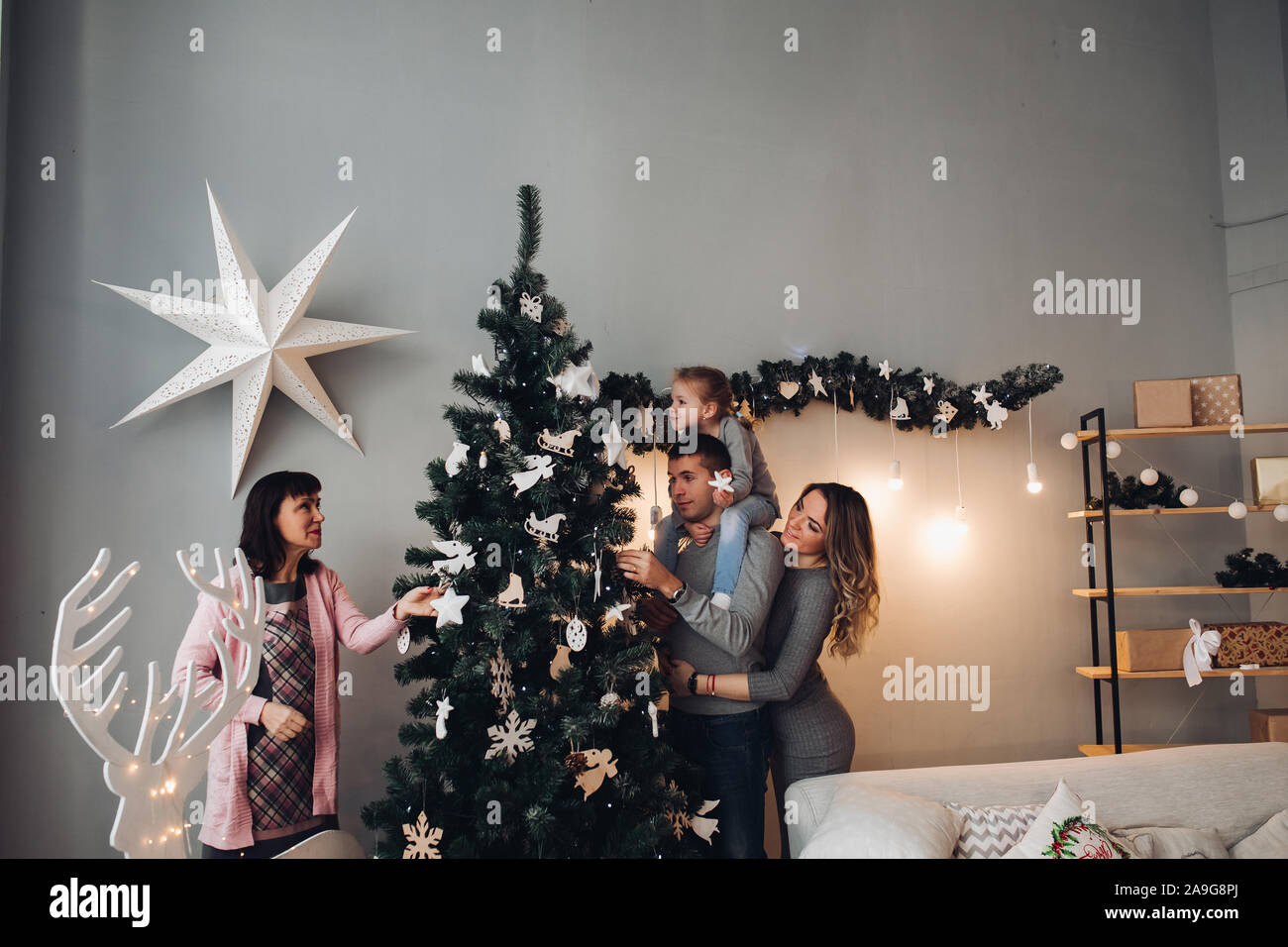 Family decorating Christmas tree together. Christmas tree Stock Photo ...