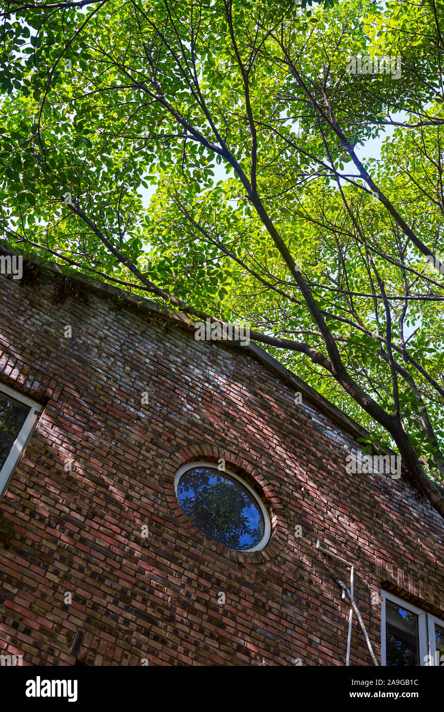 Old-fashioned red brick houses with circular windows Stock Photo - Alamy
