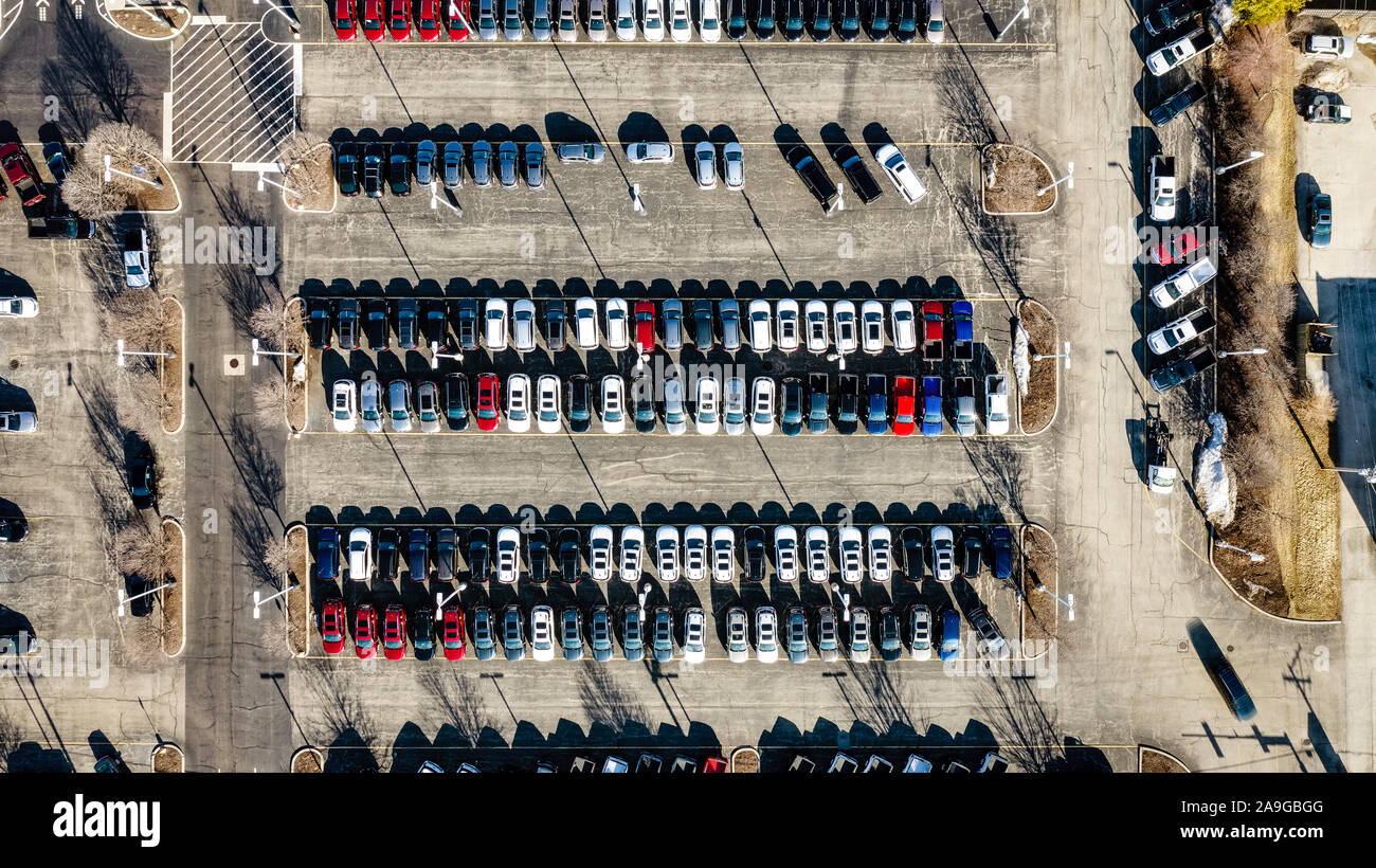 An aerial / drone view of a car dealership and parking lot with cars ...