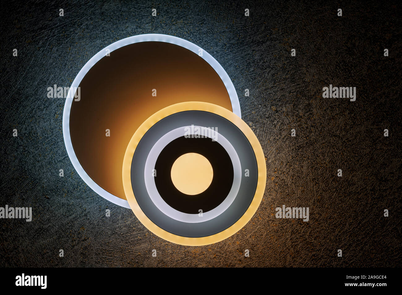 Round LED wall lights on a dark background Stock Photo - Alamy