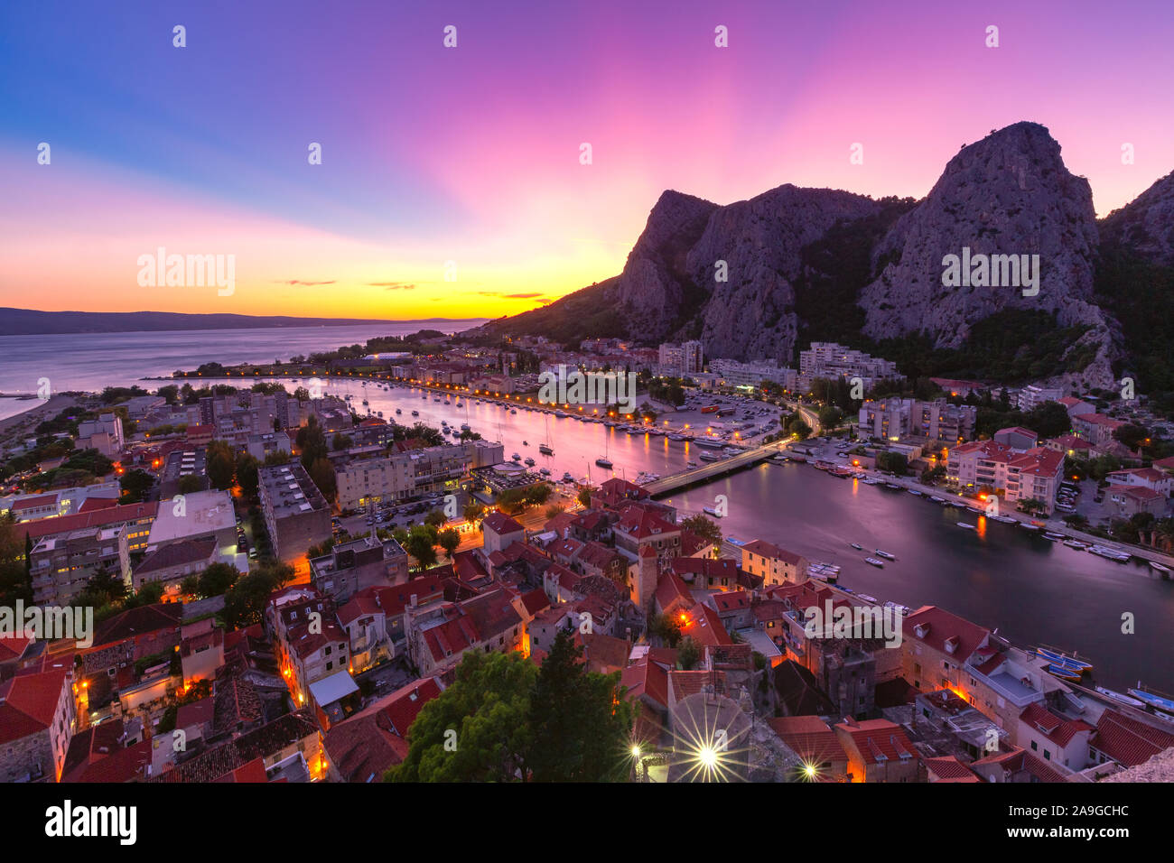 Beautiful aerial panoramic view of Cetina river, mountains and Old town at sunset, Omis, very ...