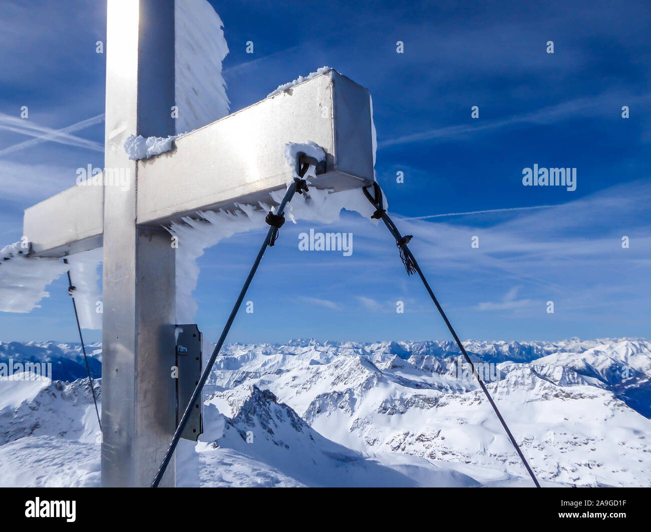 A snow and ice covered cross on top of Mölltaler Gletscher, Austria ...