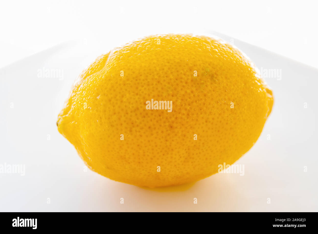 Lemon fruit foreground on a white background. Whole lemon, studio macro ...