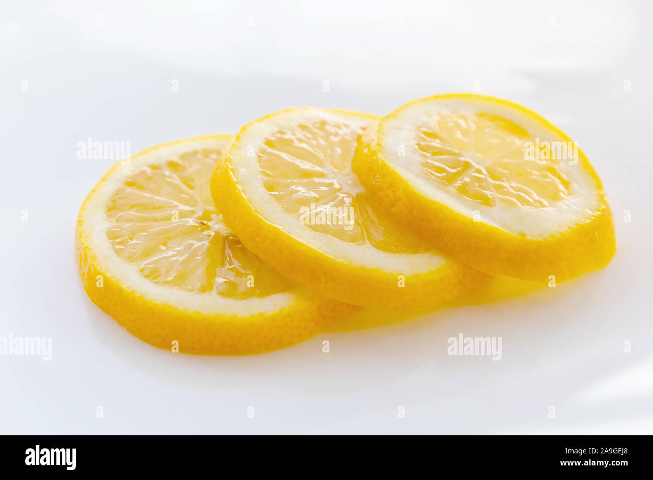 Lemon fruit foreground on a white background. Sliced lemon, studio ...
