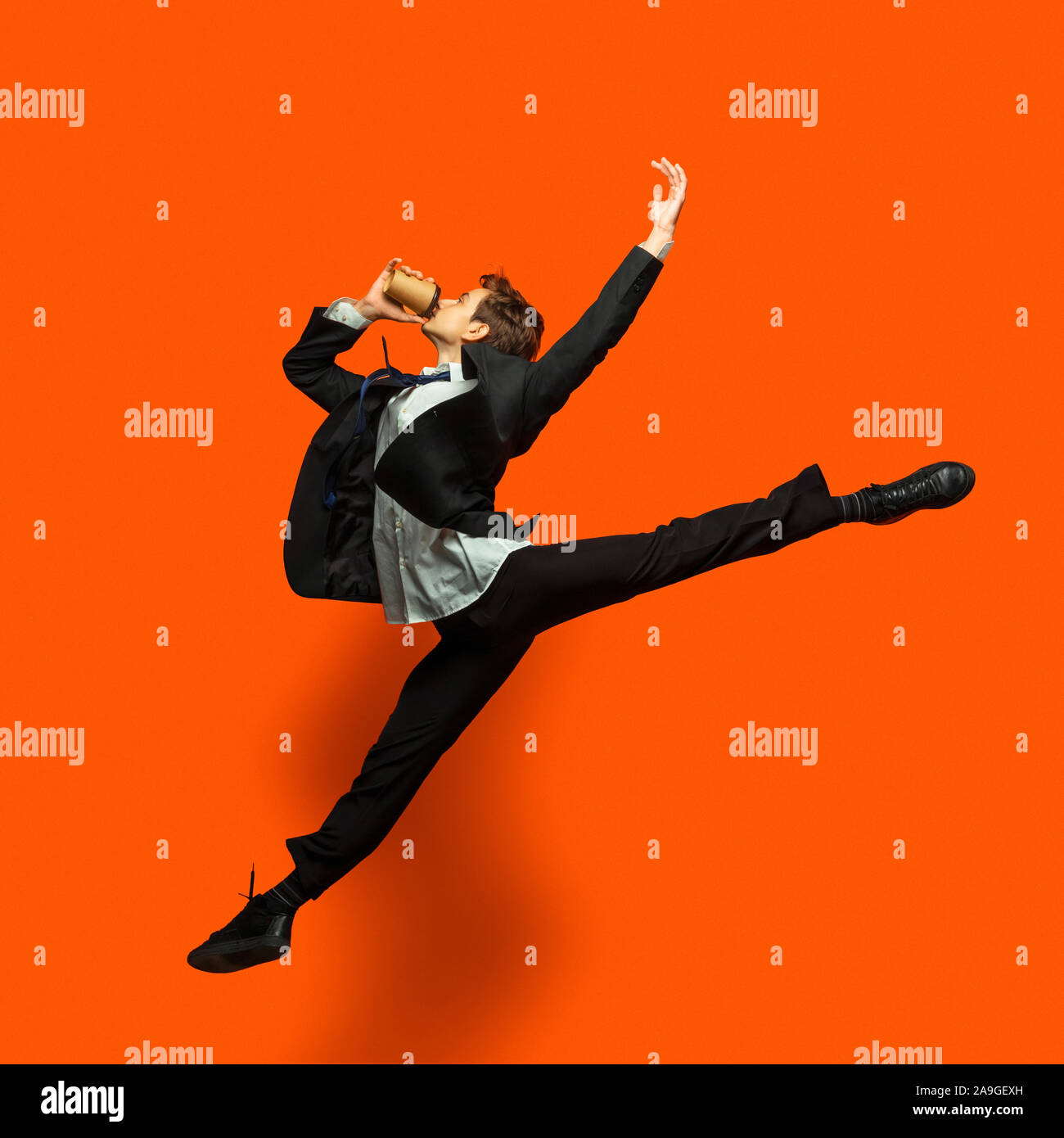 Man in casual office style clothes jumping and dancing isolated on ...