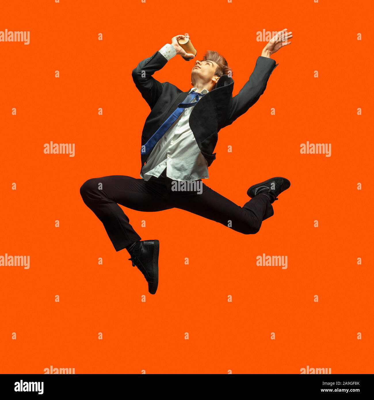 Man in casual office style clothes jumping and dancing isolated on ...