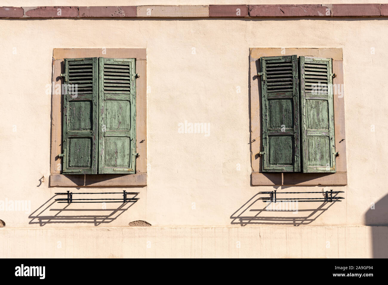 Old shuttered windows on old buildings in Eguisheim Alsace France ...