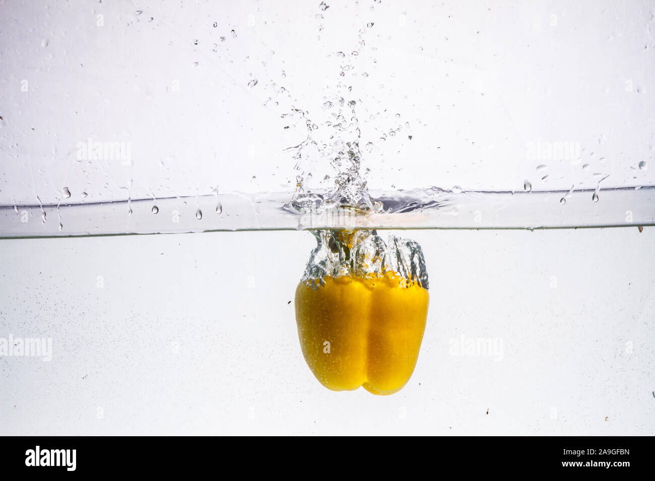 Orange peppers splashing in to water hi-res stock photography and ...